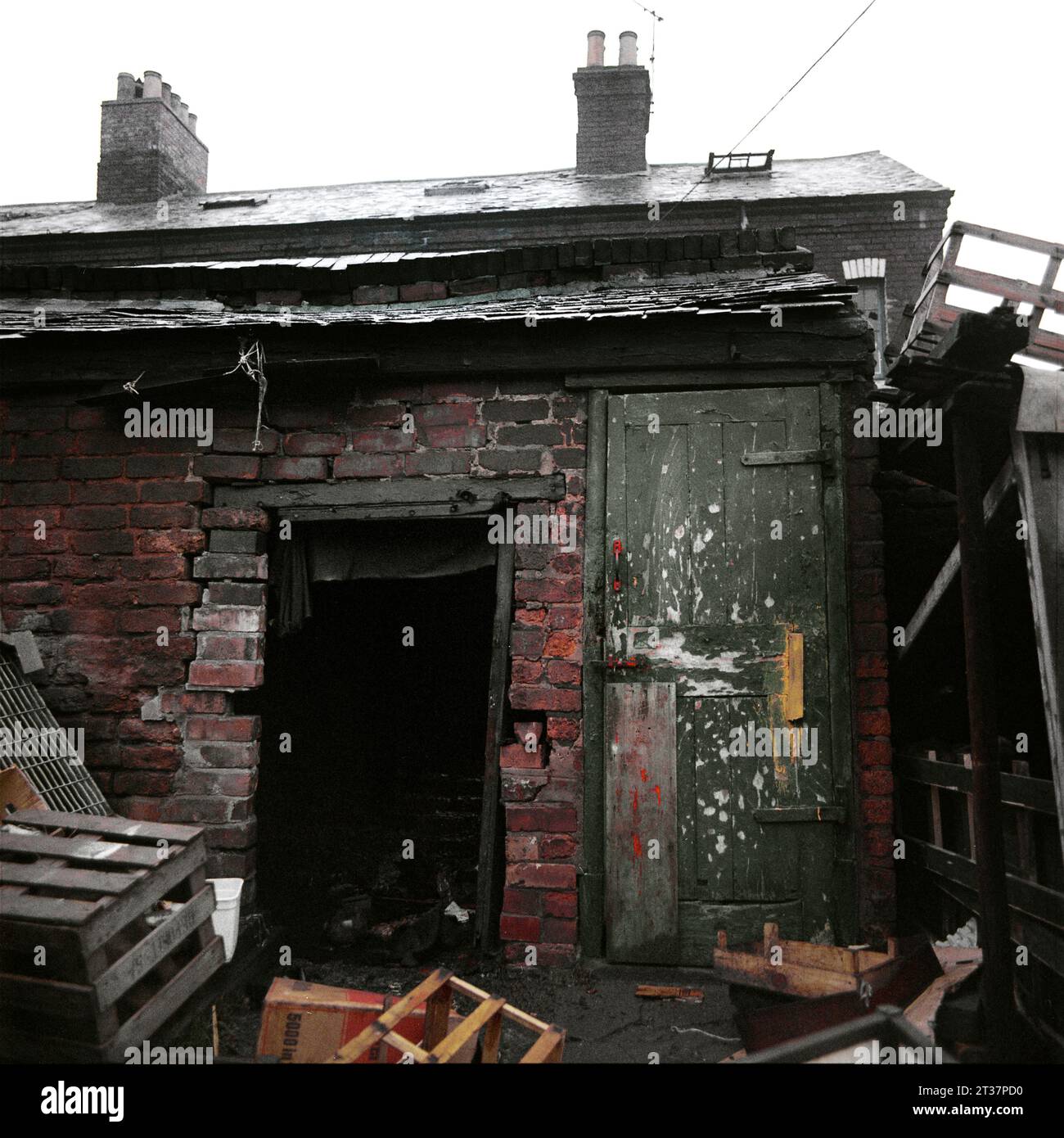 Piles of discarded items such as wooden crates in the backyard of a ...