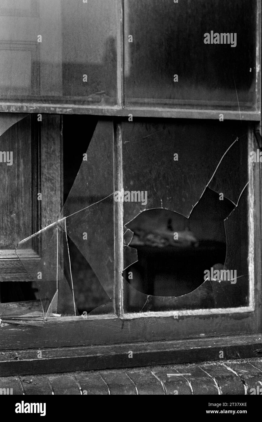 Broken glass window of a house that is awaiting demolition. Photo taken ...