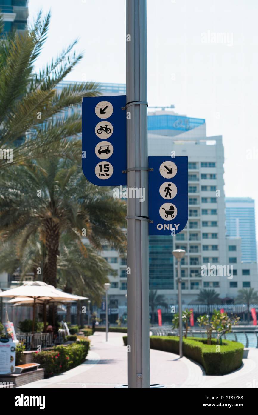 A metal signpost with signs attached, indicating separate lanes for ...