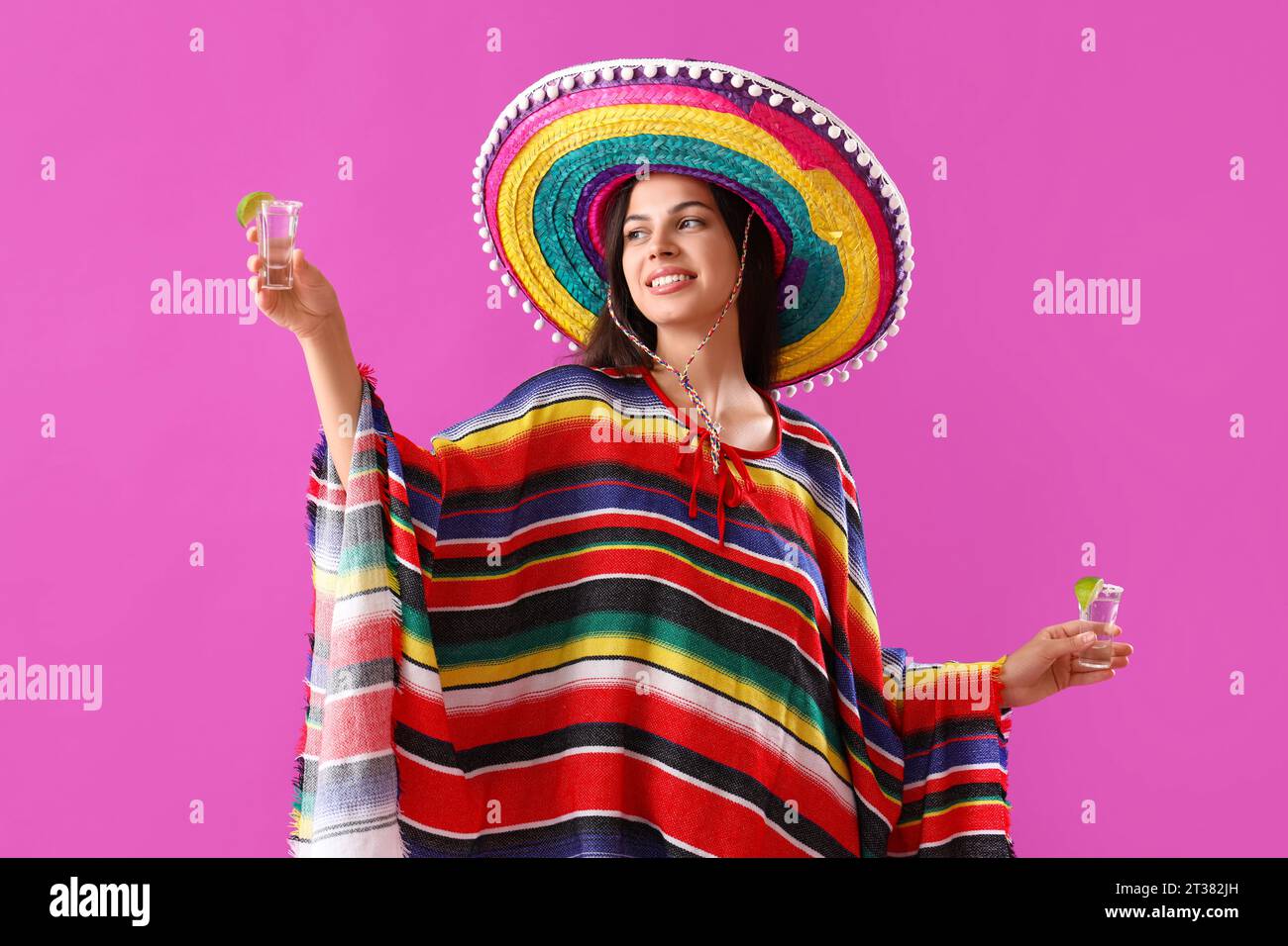 Beautiful young Mexican woman with tequila on magenta background Stock ...