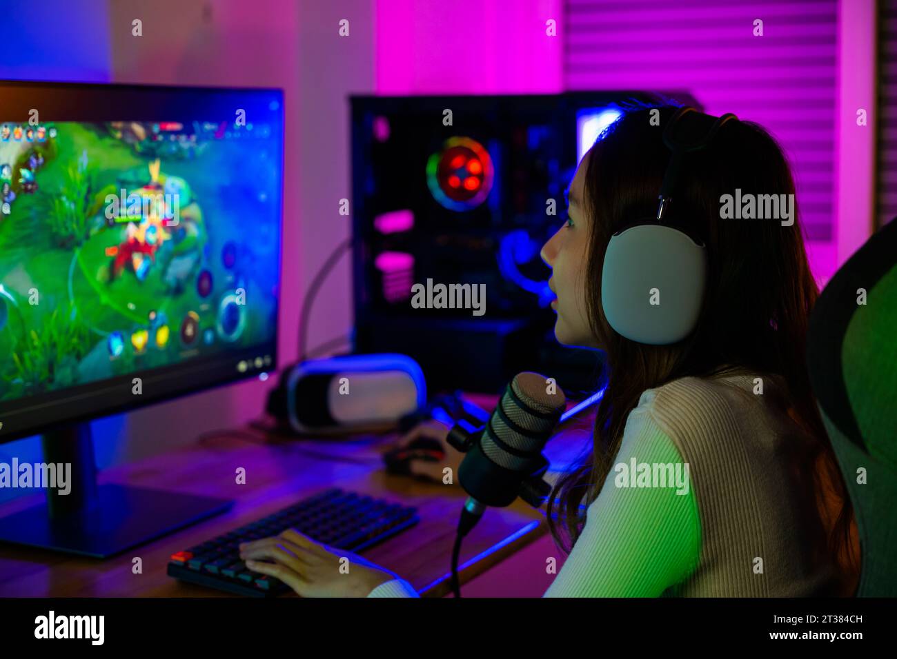 Asian young gamer woman playing video games online on computer she live ...