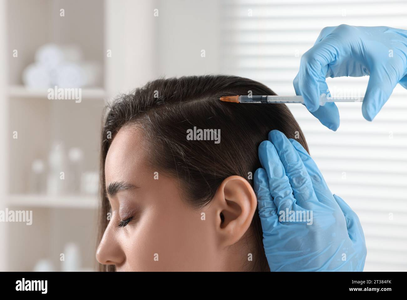 Trichologist giving injection to patient in clinic, closeup Stock Photo ...