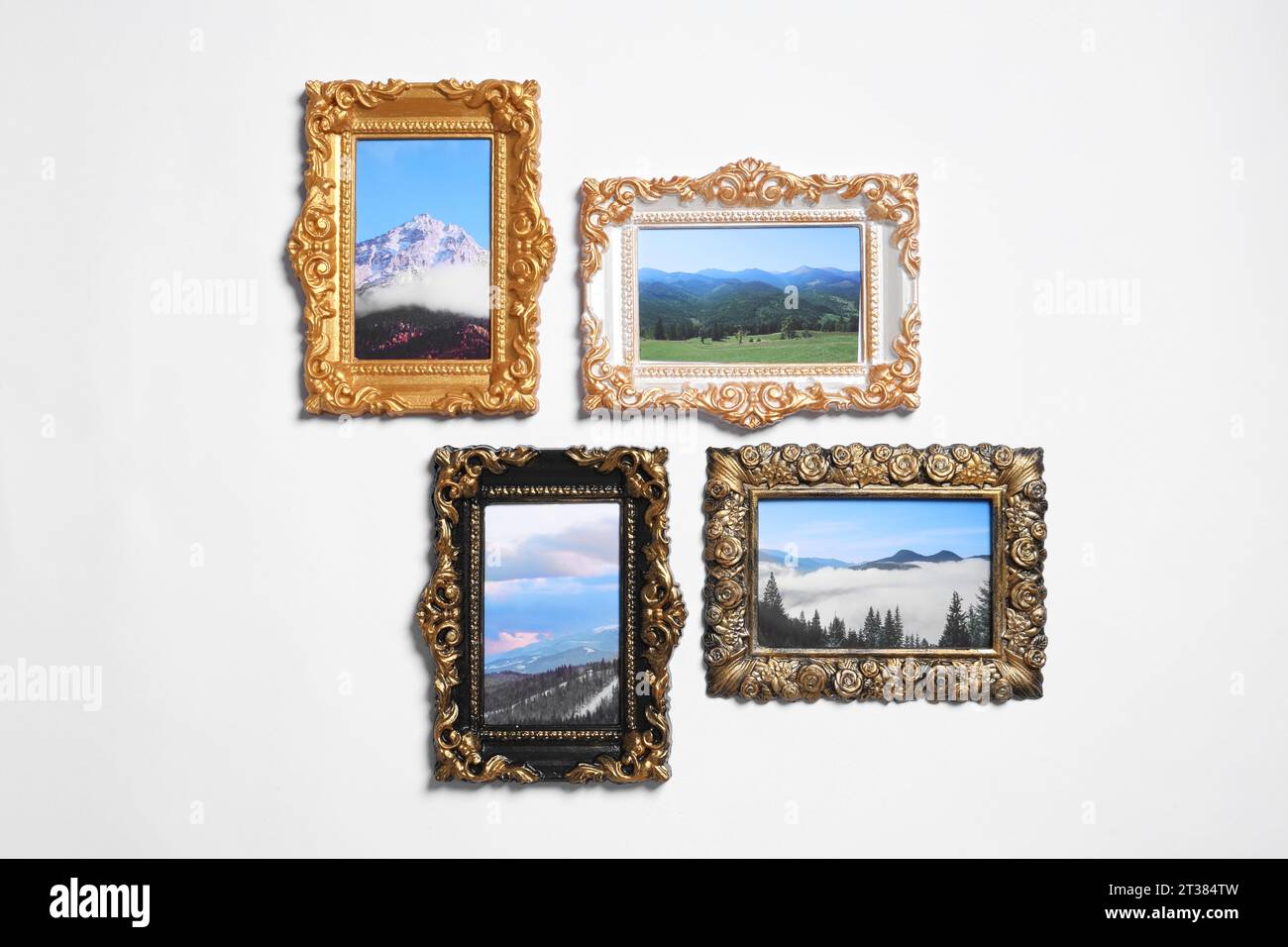 Vintage frames with photos of beautiful landscapes hanging on white ...