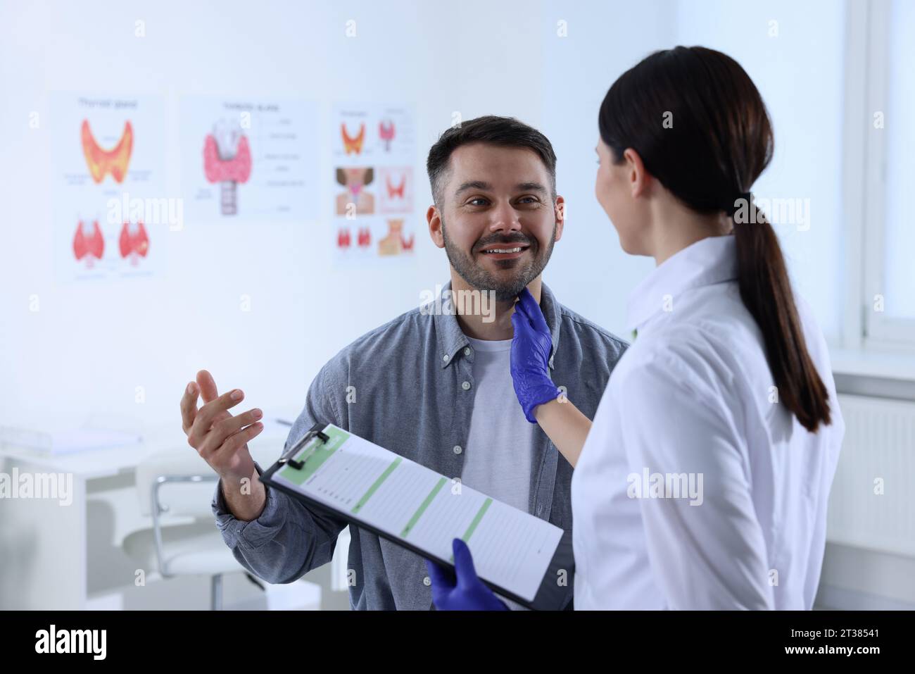 Endocrinologist examining thyroid gland of patient at hospital Stock ...