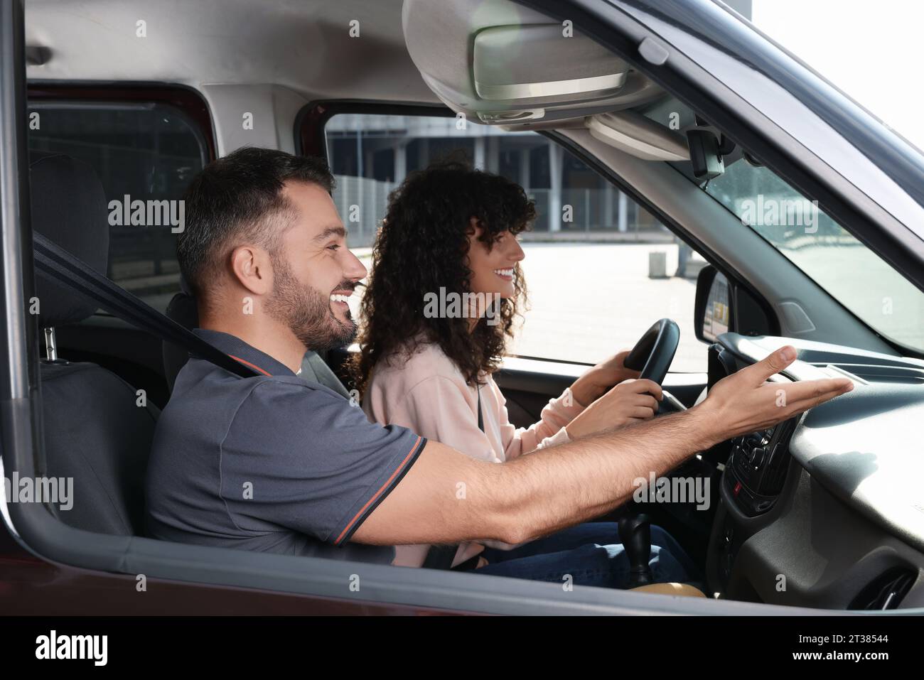 Driving school. Student during lesson with driving instructor in car at ...