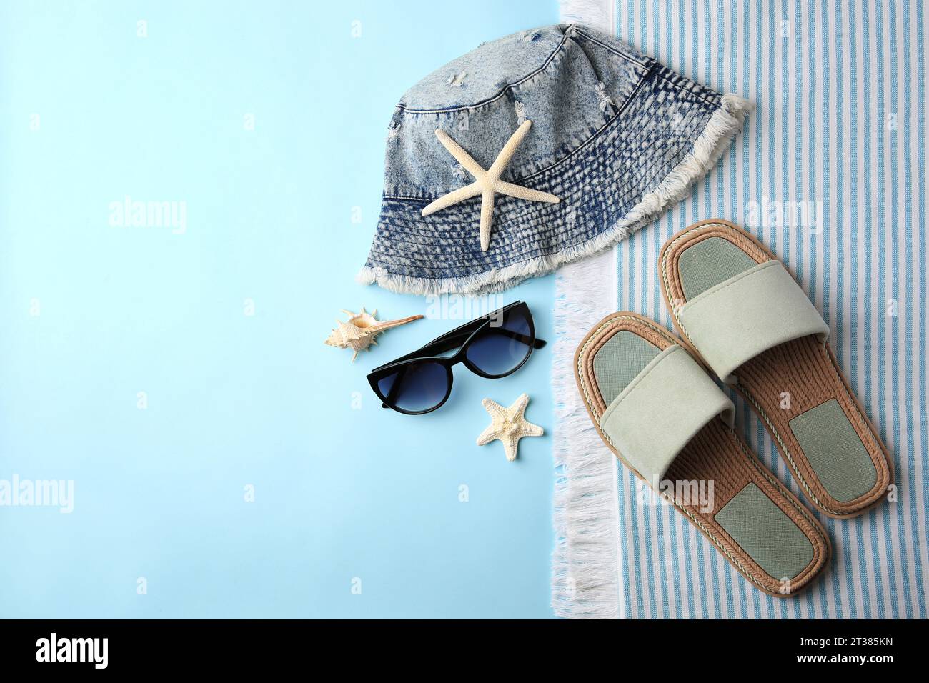 Flat lay composition with beach accessories on light blue background ...