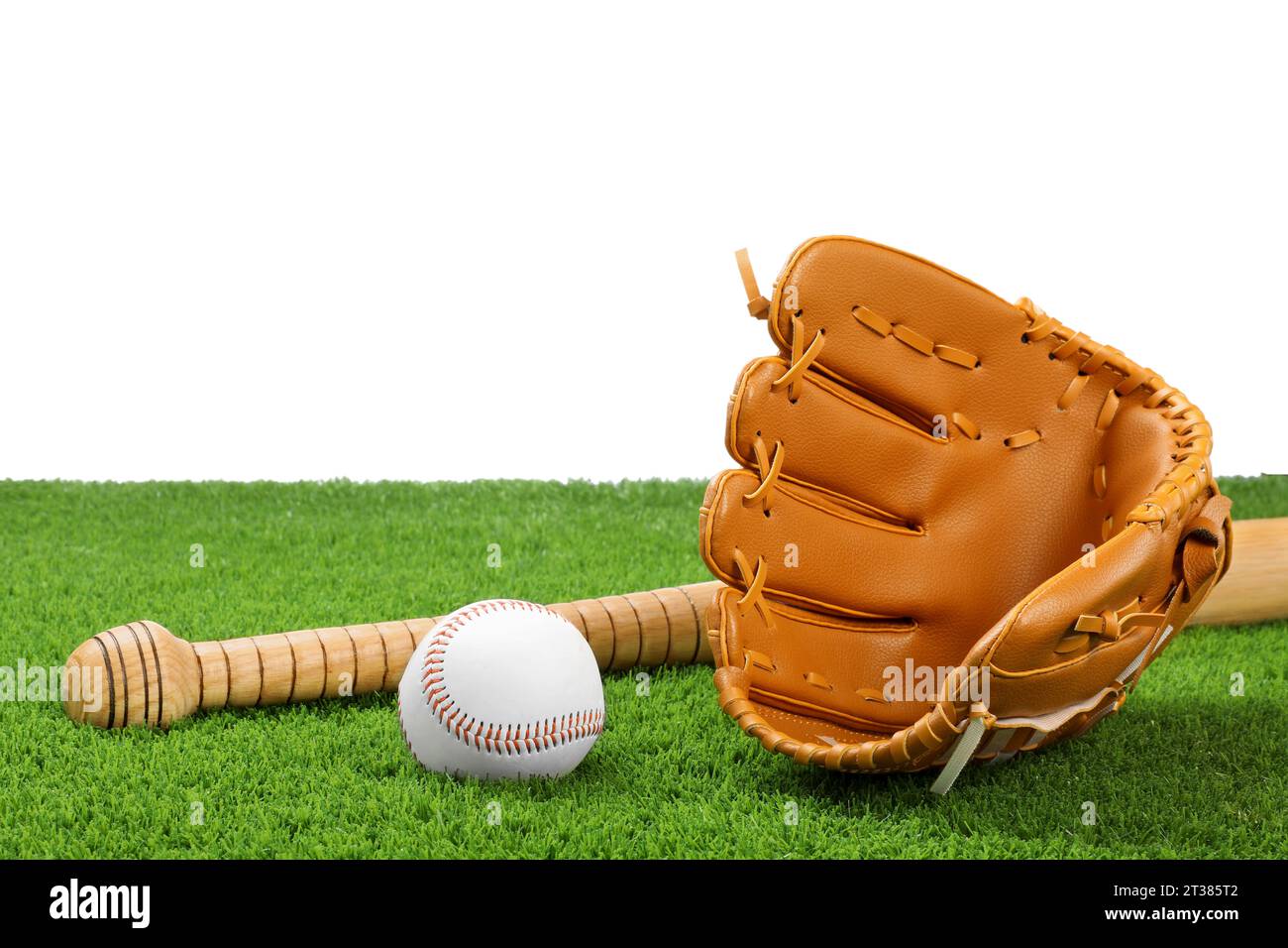 Baseball bat, ball and catcher's mitt on artificial grass against white ...