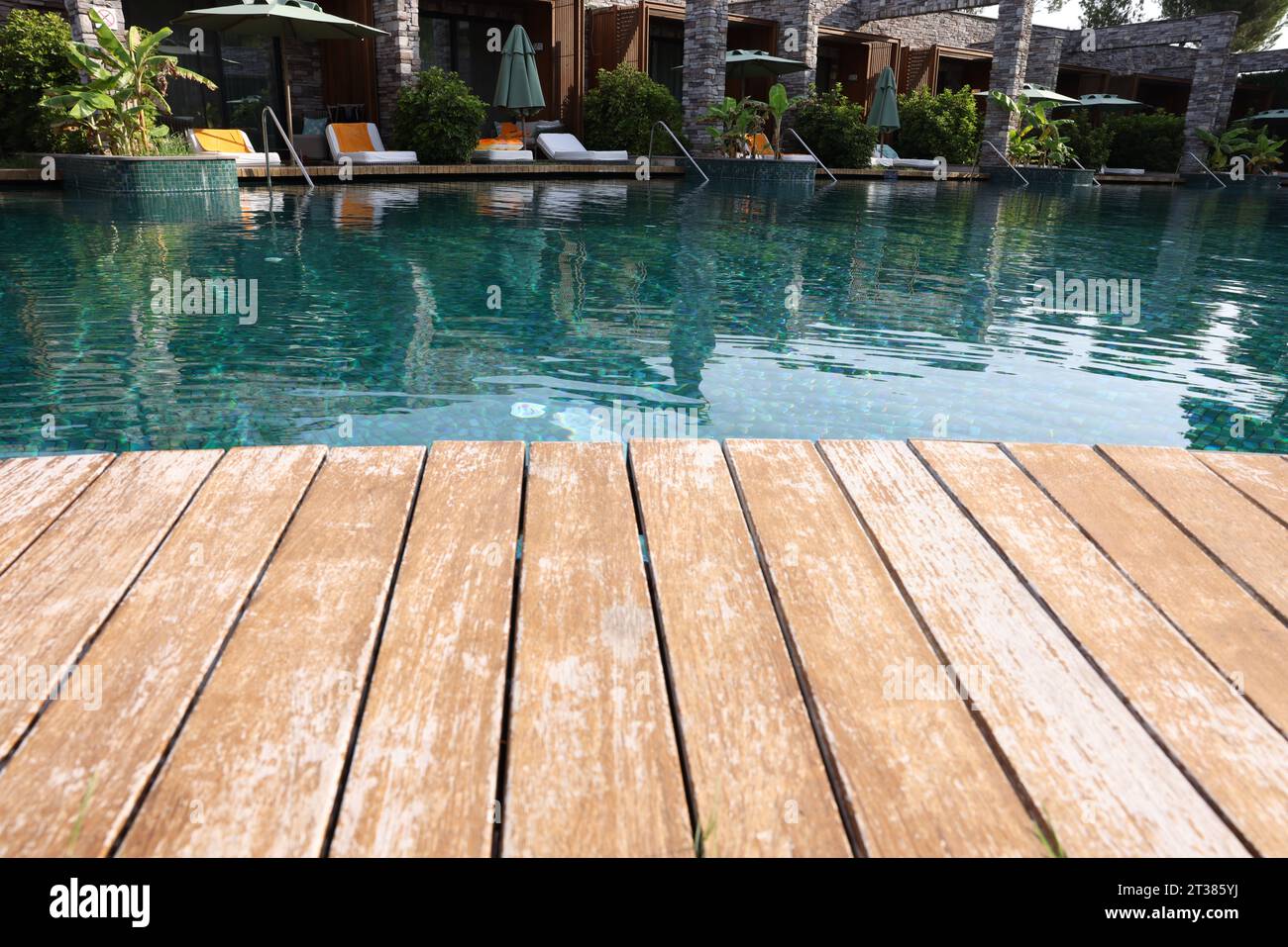 Wooden deck, swimming pool and recreational area at luxury resort Stock ...