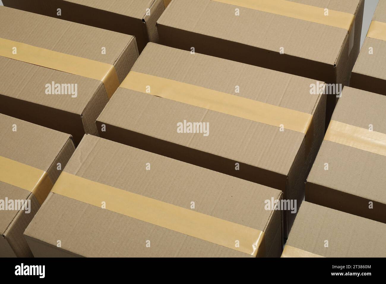 Many closed cardboard boxes with tape as background Stock Photo - Alamy