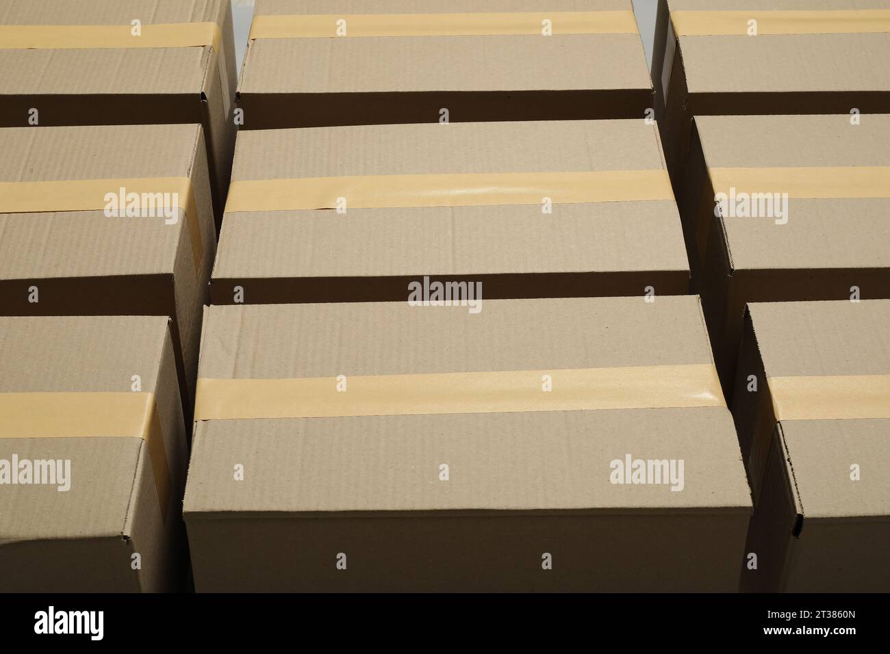 Many closed cardboard boxes with tape as background Stock Photo - Alamy
