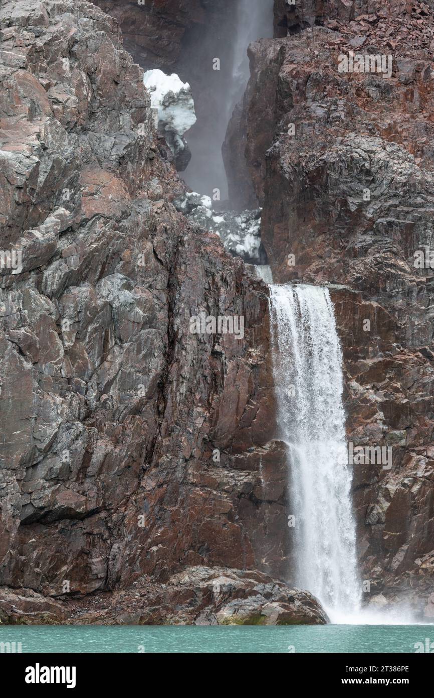 Waterfall falling into the sea in arctic landscape Stock Photo - Alamy