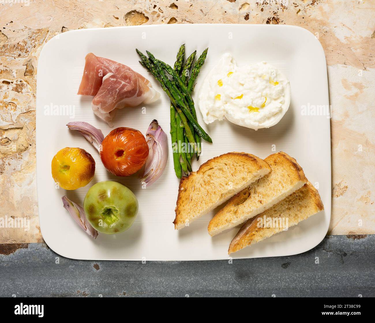 Appetizer plate above view with poached egg, prosciutto, onions ...
