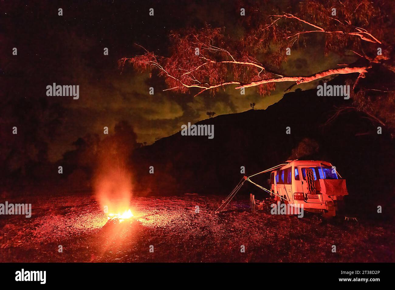 Toyota Coaster motorhome bushcamping with a campfire on under a starry ...