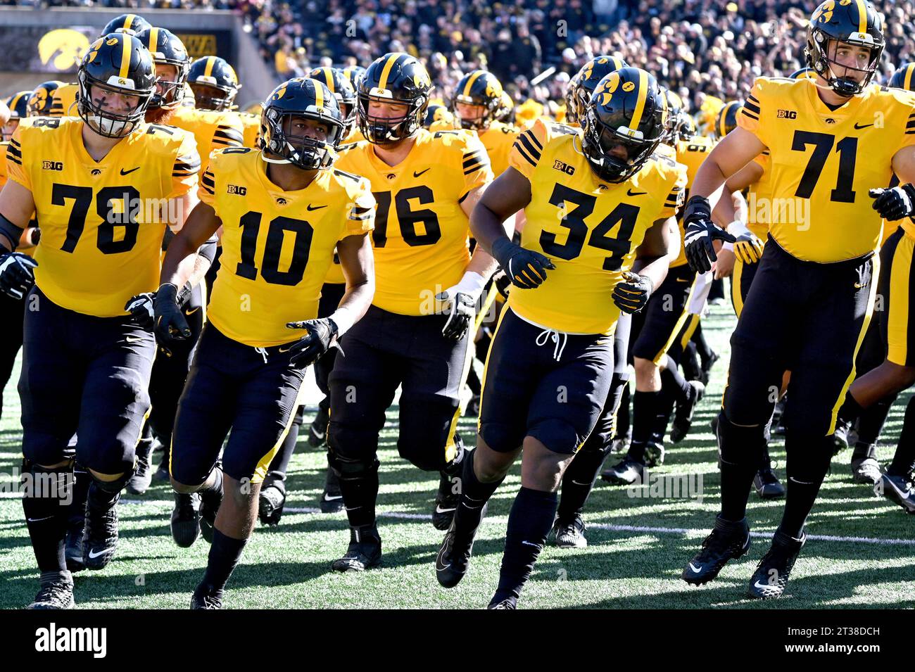 IOWA CITY, IA - OCTOBER 21: Iowa players swarm onto the field before a ...