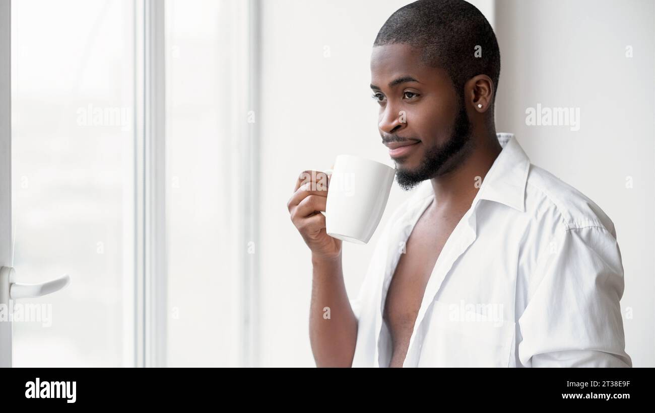 Morning coffee contemplation man mug window home Stock Photo - Alamy