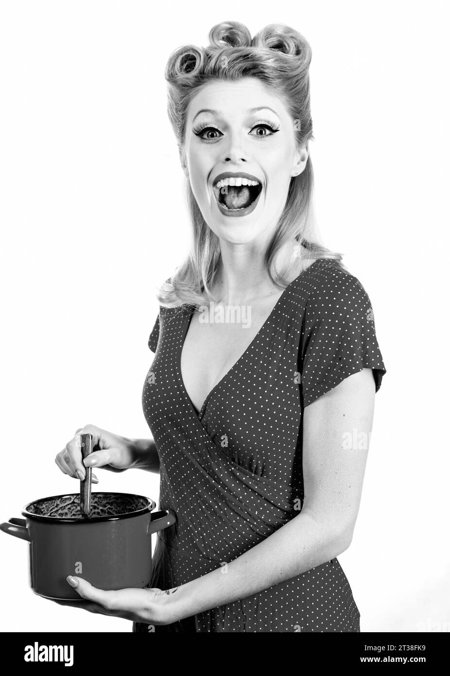 Funny woman winking in the kitchen and cooking Stock Photo - Alamy