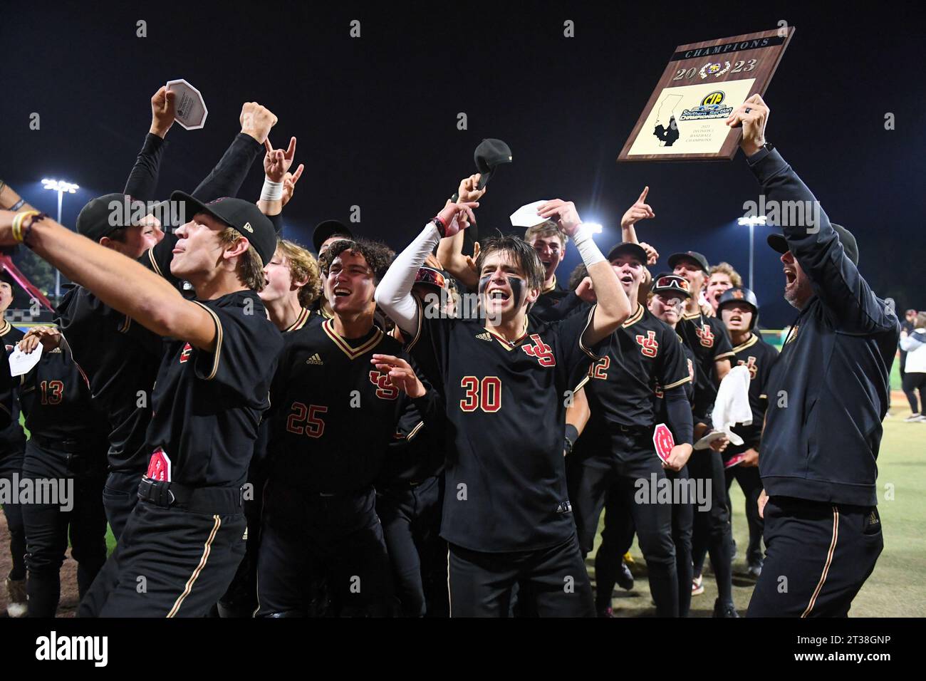 JSerra Lions assistant coach Bob Ickes presents the championship trophy ...