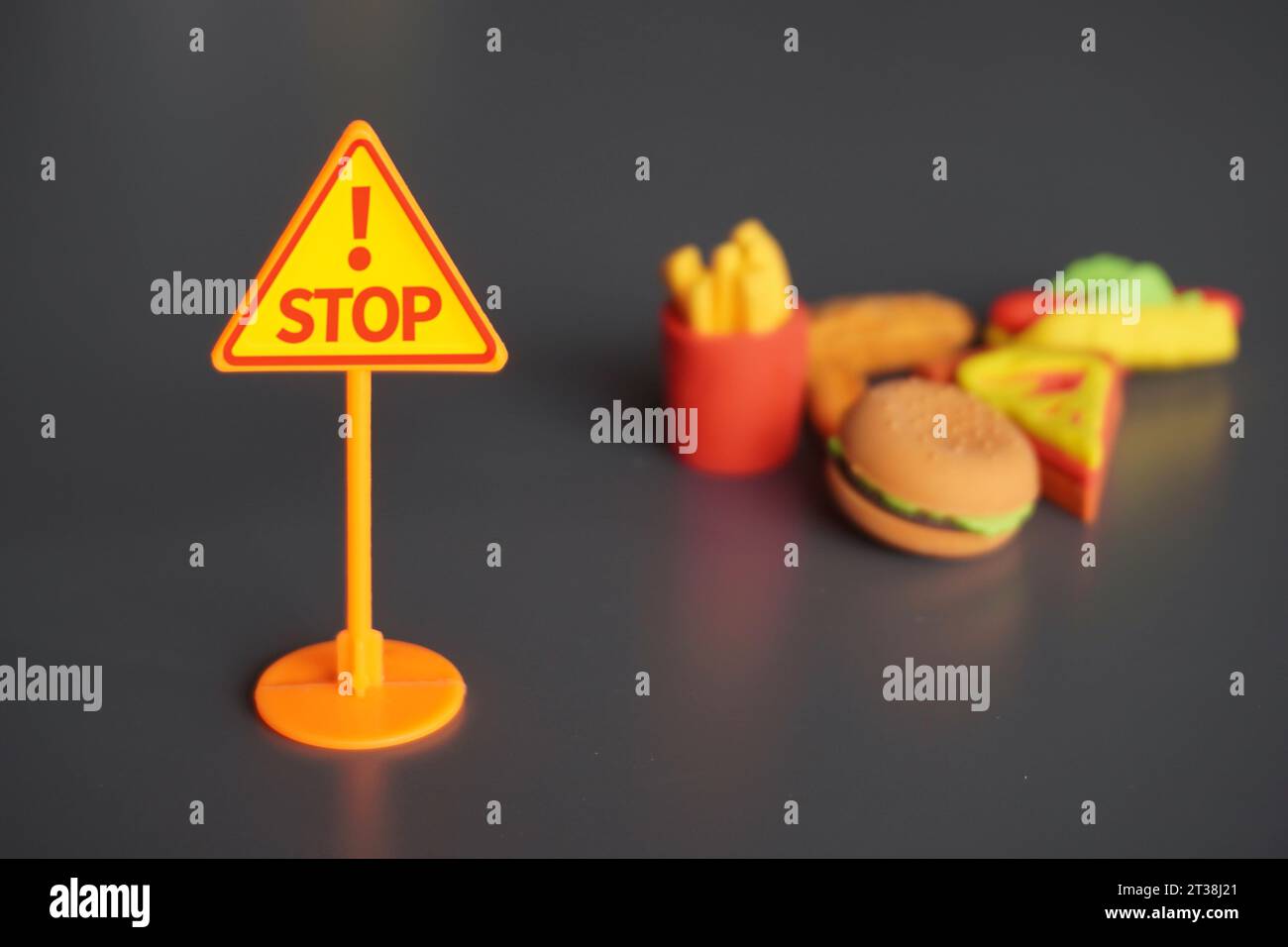Closeup image of STOP signboard and junk foods. Stop eating unhealthy ...
