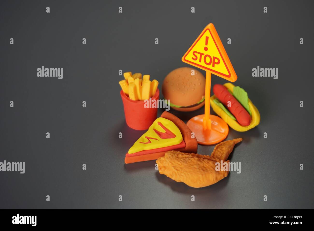 Closeup image of STOP signboard and junk foods. Stop eating unhealthy ...