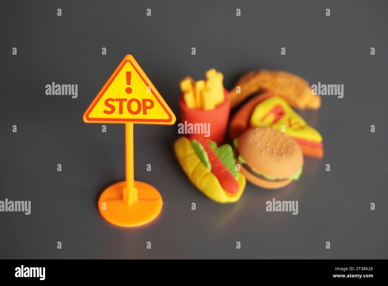 Closeup image of STOP signboard and junk foods. Stop eating unhealthy ...