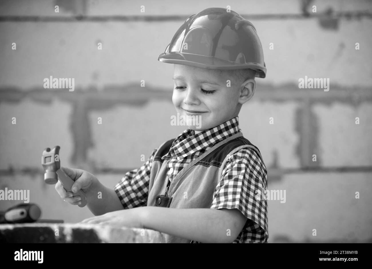 Portrait of little builder in hardhats with instruments for renovation ...