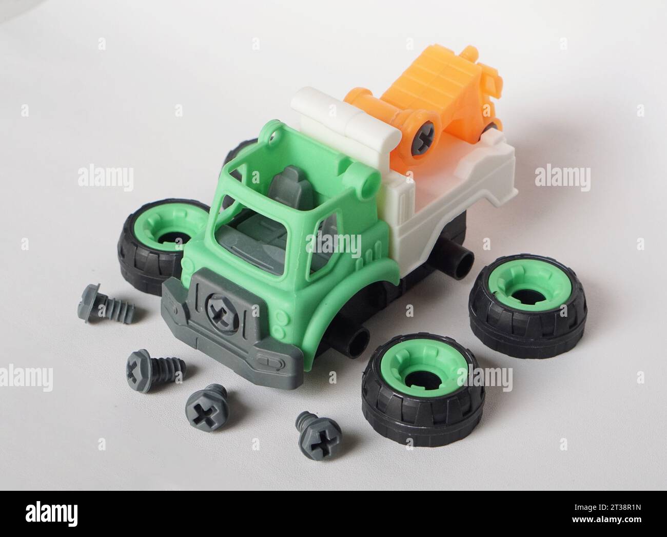 plastic towing truck toy with bolt and screwdriver isolated on white ...