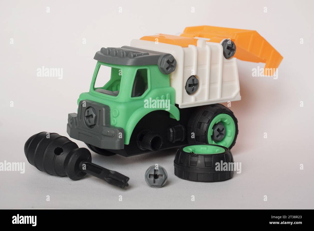 plastic towing truck toy with bolt and screwdriver isolated on white ...