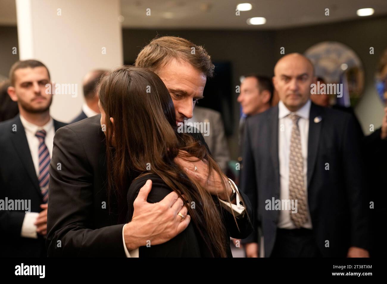 French President Emmanuel Macron hugs a woman as he meets Israeli ...