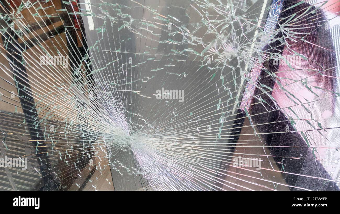 Broken shop impact of stone and hammer on door facade store window ...