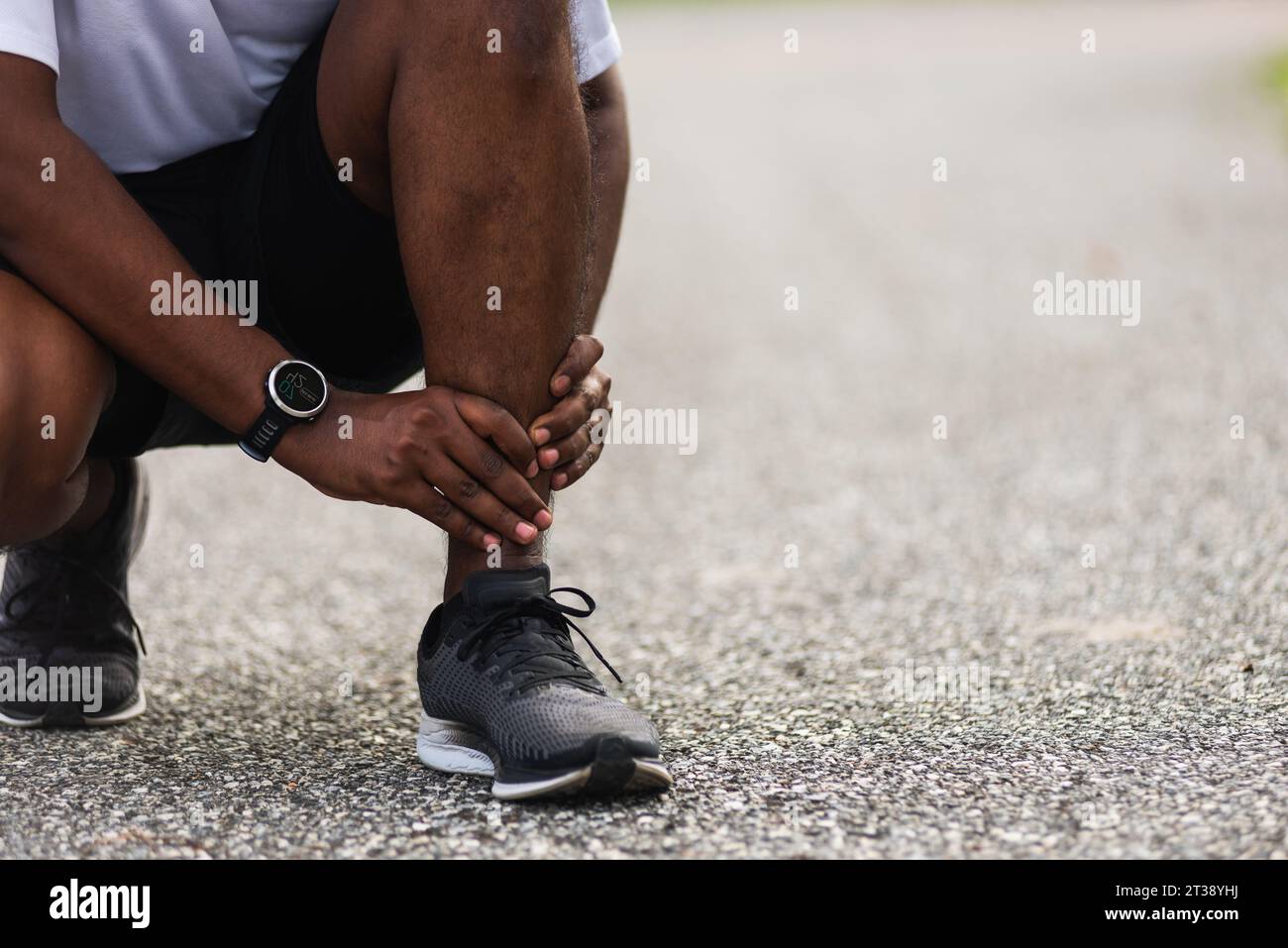 sport runner man use hands joint hold leg pain because of twisted ankle ...