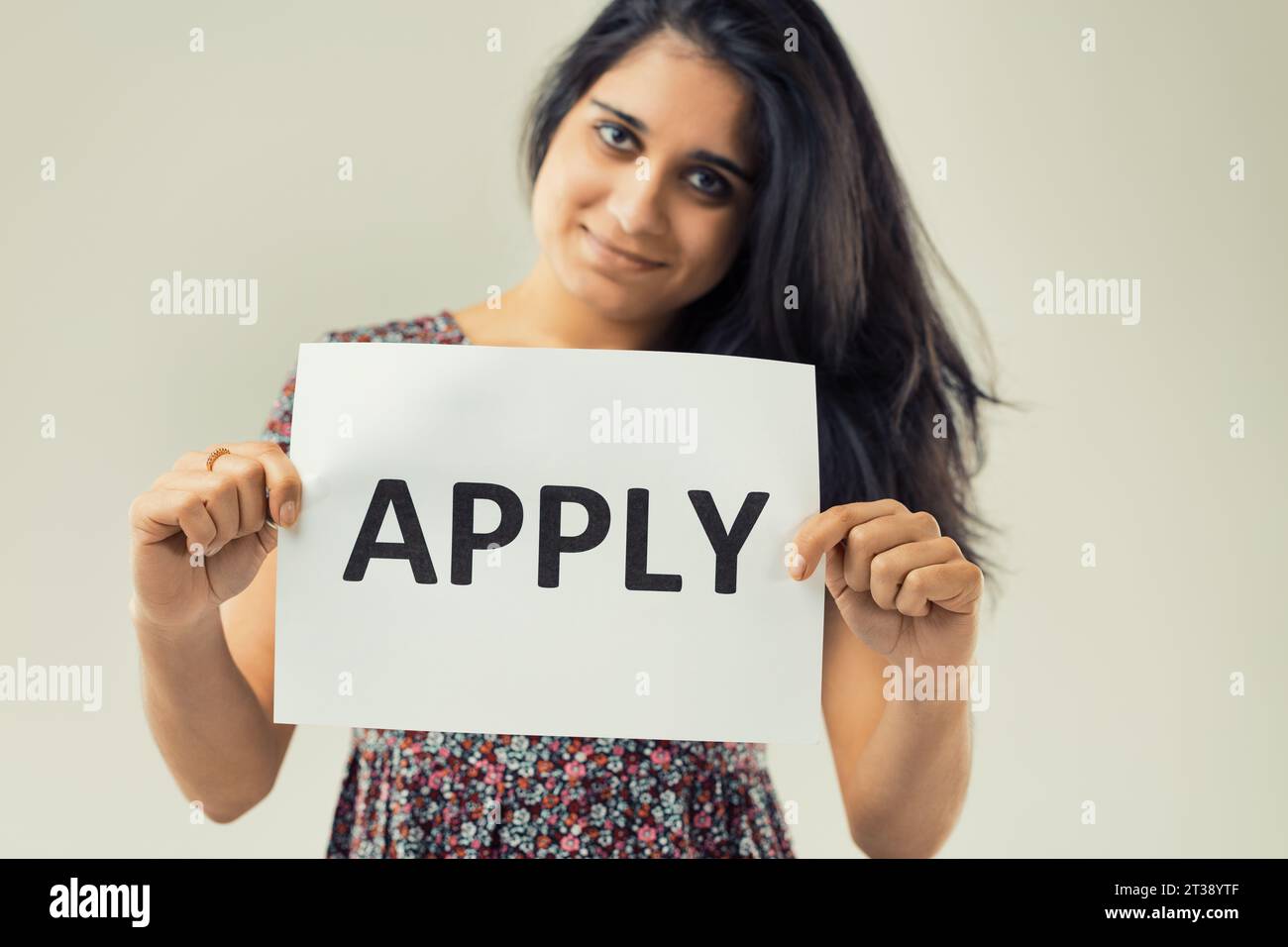 woman with expressive eyes and flowing dark hair confidently holds a ...