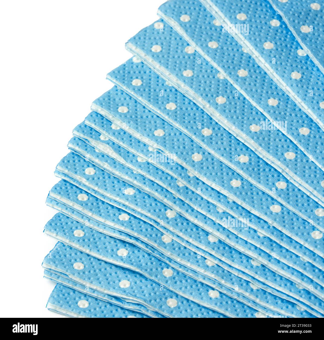 Stack of blue dotted paper napkins isolated on white Stock Photo - Alamy