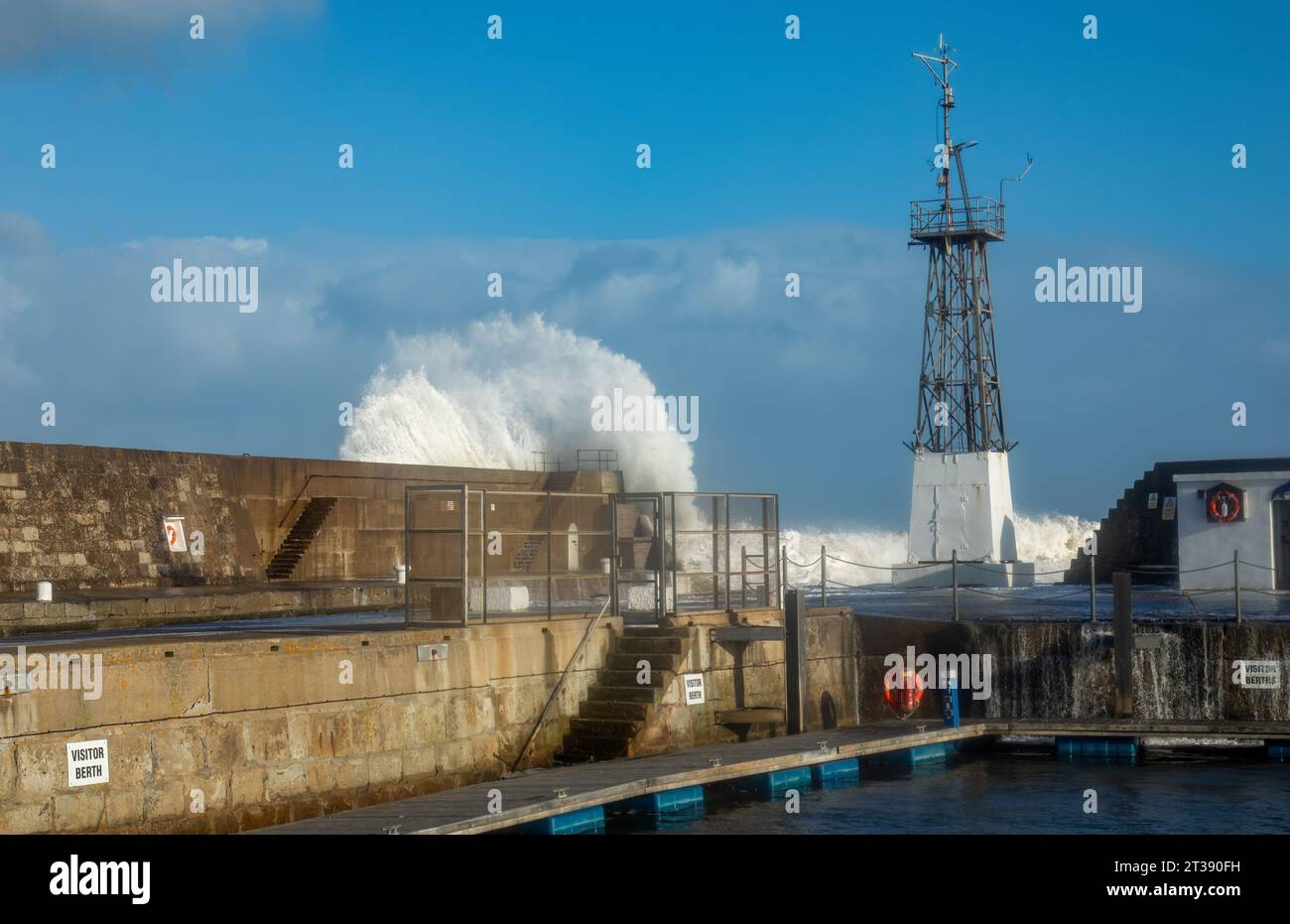 Very high waves coming over a harbour wall during a storm Stock Photo ...
