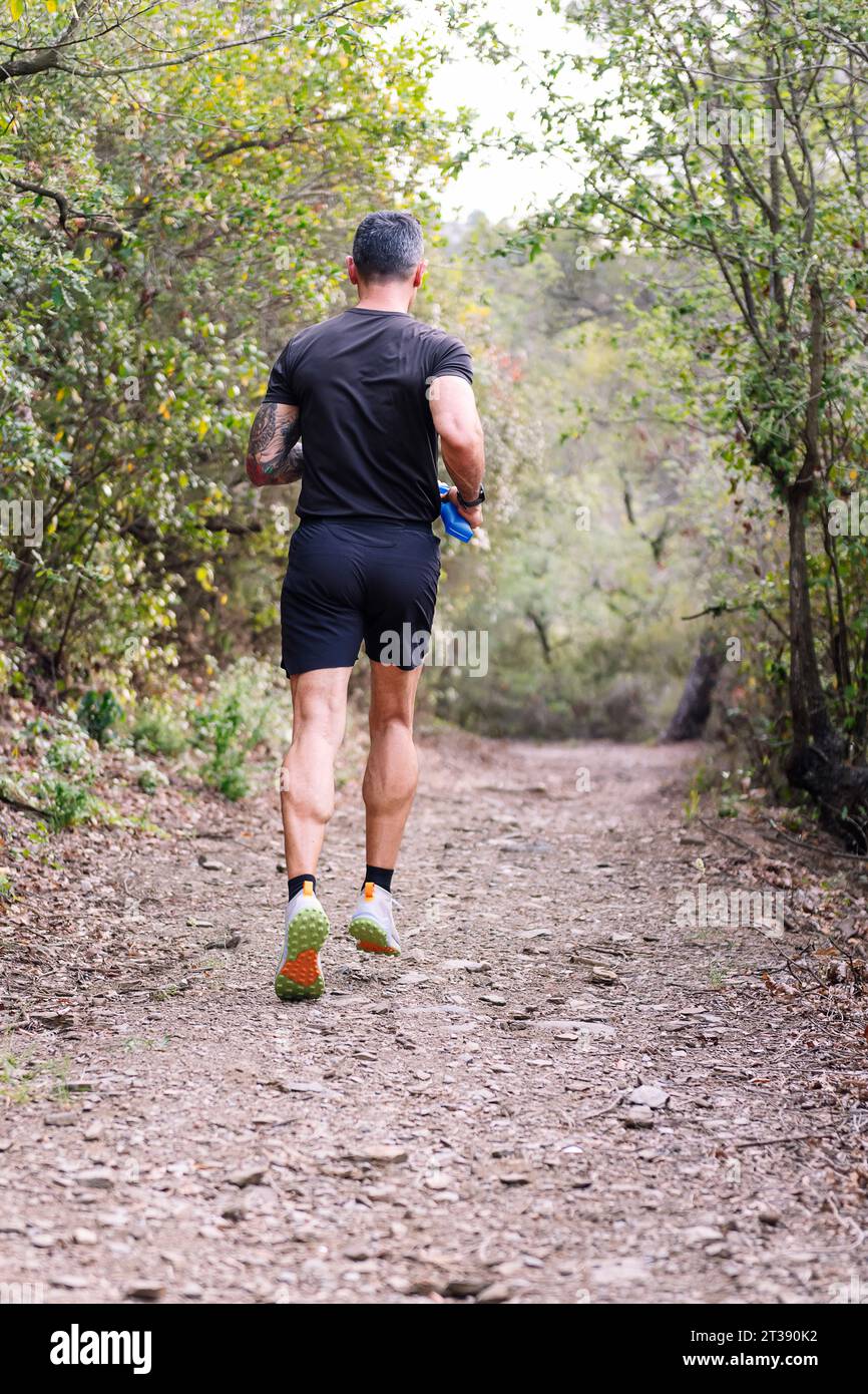 Rear view running man hi-res stock photography and images - Alamy