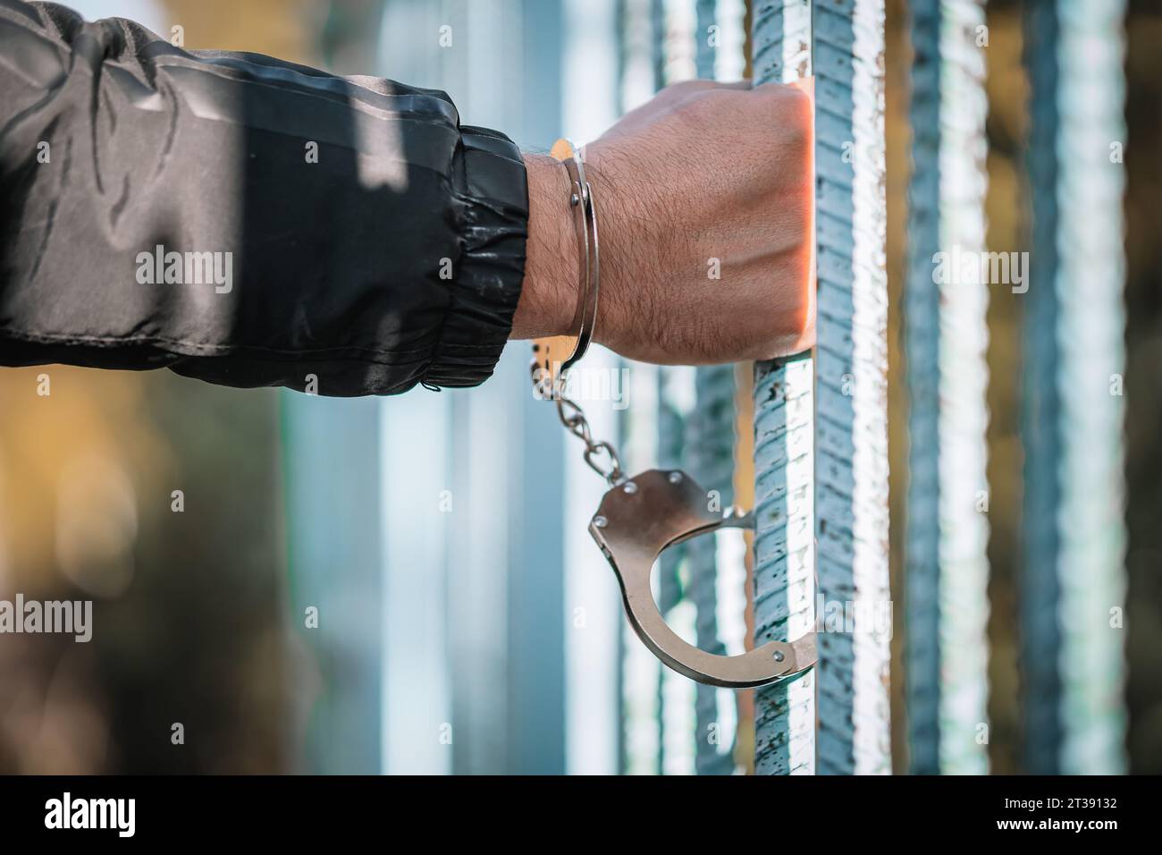 Man handcuffed in jail outdoors, closeup. Criminal law. arrest at the ...