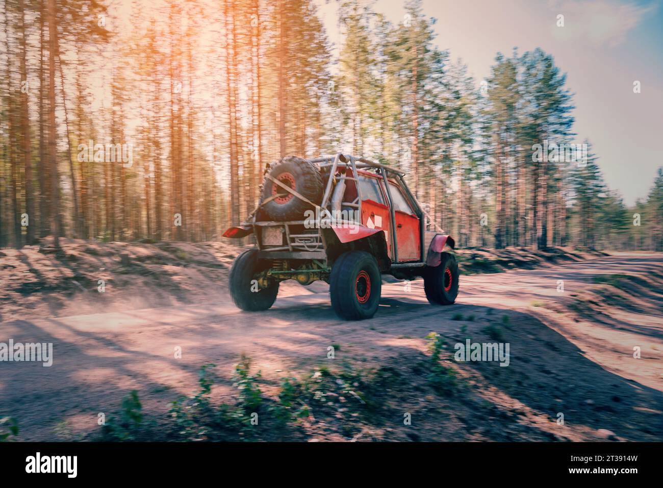 4x4 jeep SUV car is driving fast on a dusty road in the forest in a ...
