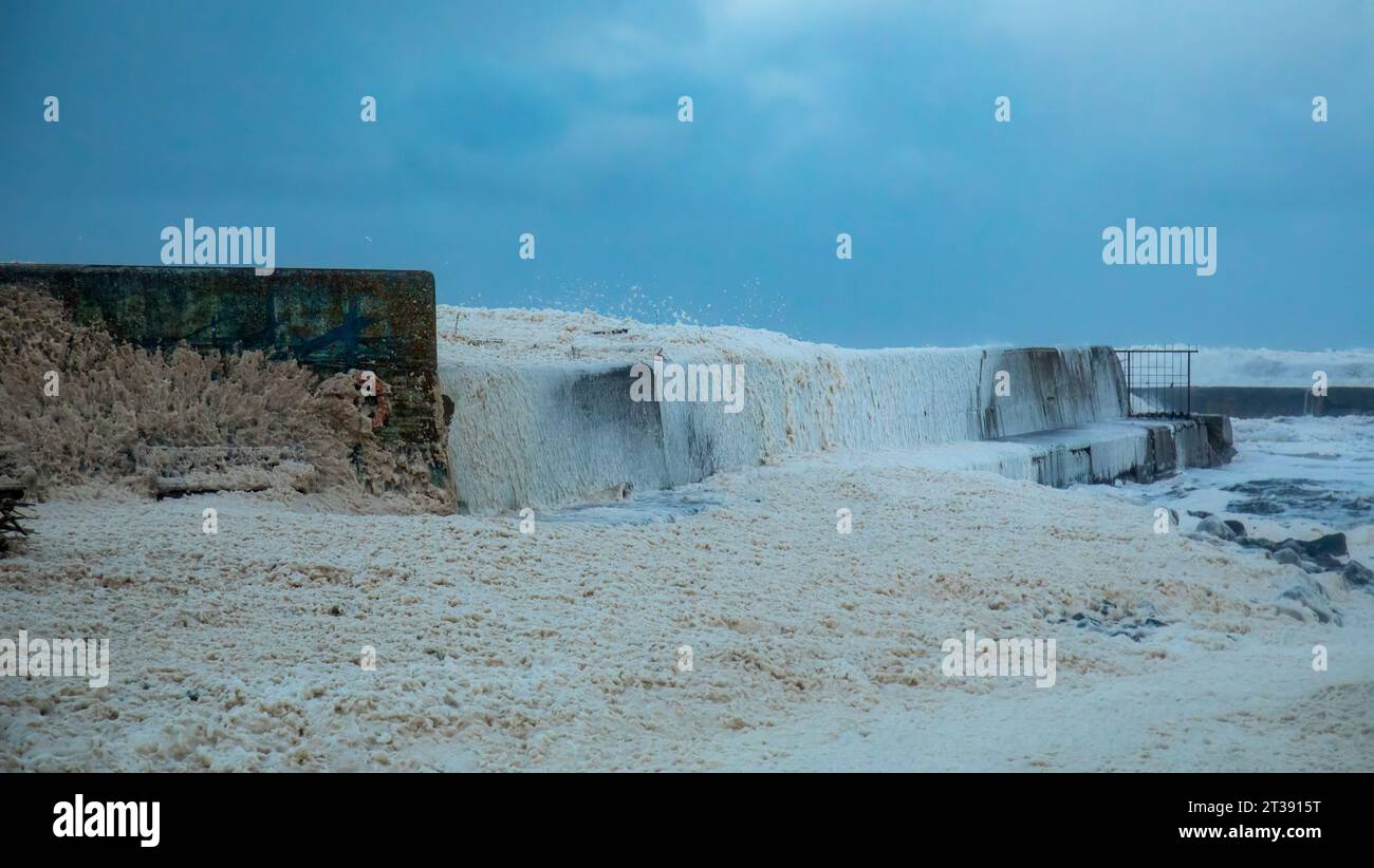Sea foam created by high seas and waves during a storm Stock Photo - Alamy