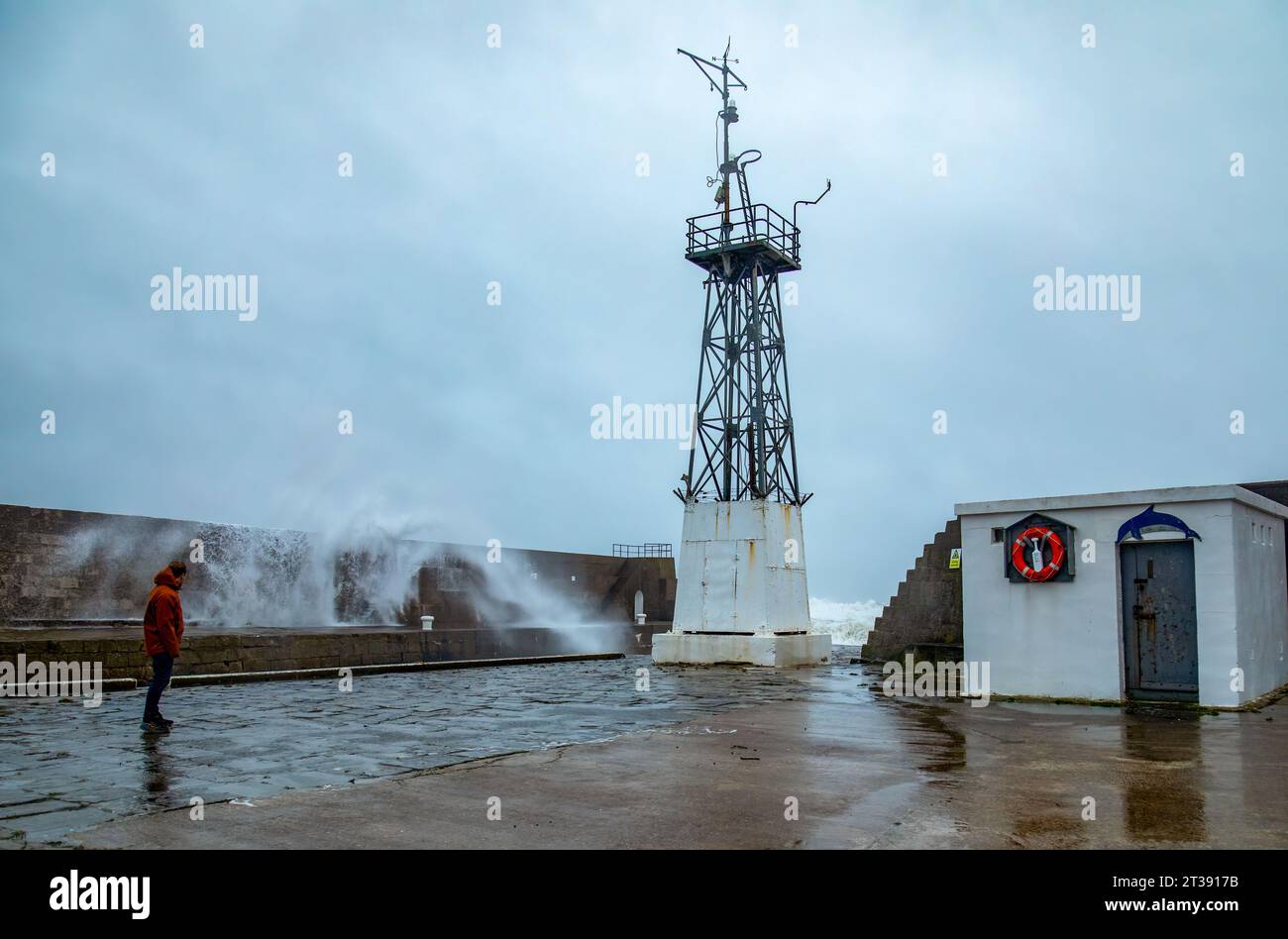 Very high waves coming over a harbour wall during a storm Stock Photo ...