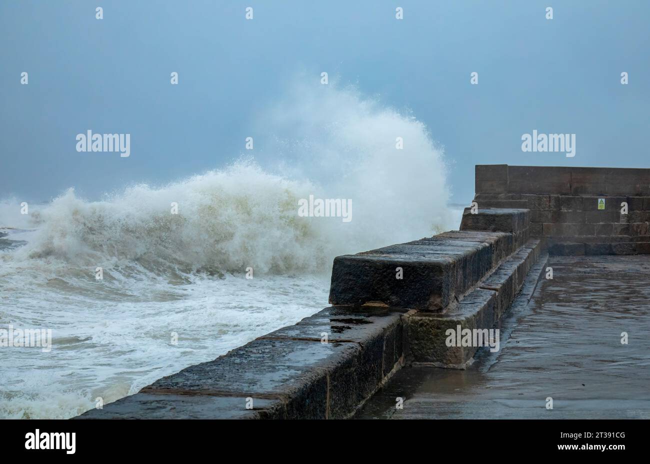 Very high waves coming over a harbour wall during a storm Stock Photo ...