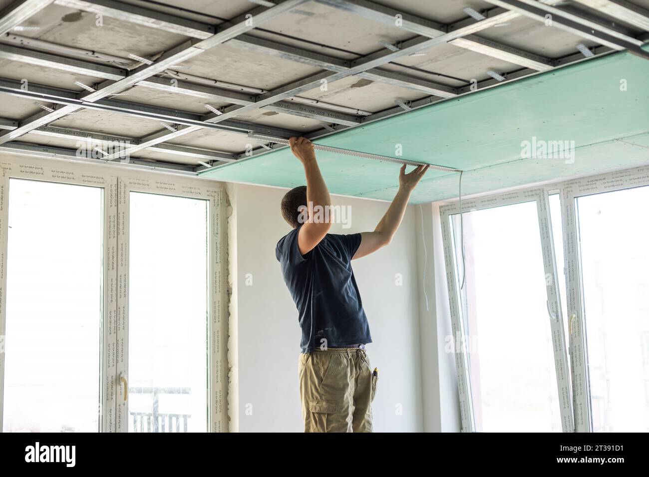 Man assembles profile metal frame for plasterboard ceilings Stock Photo ...