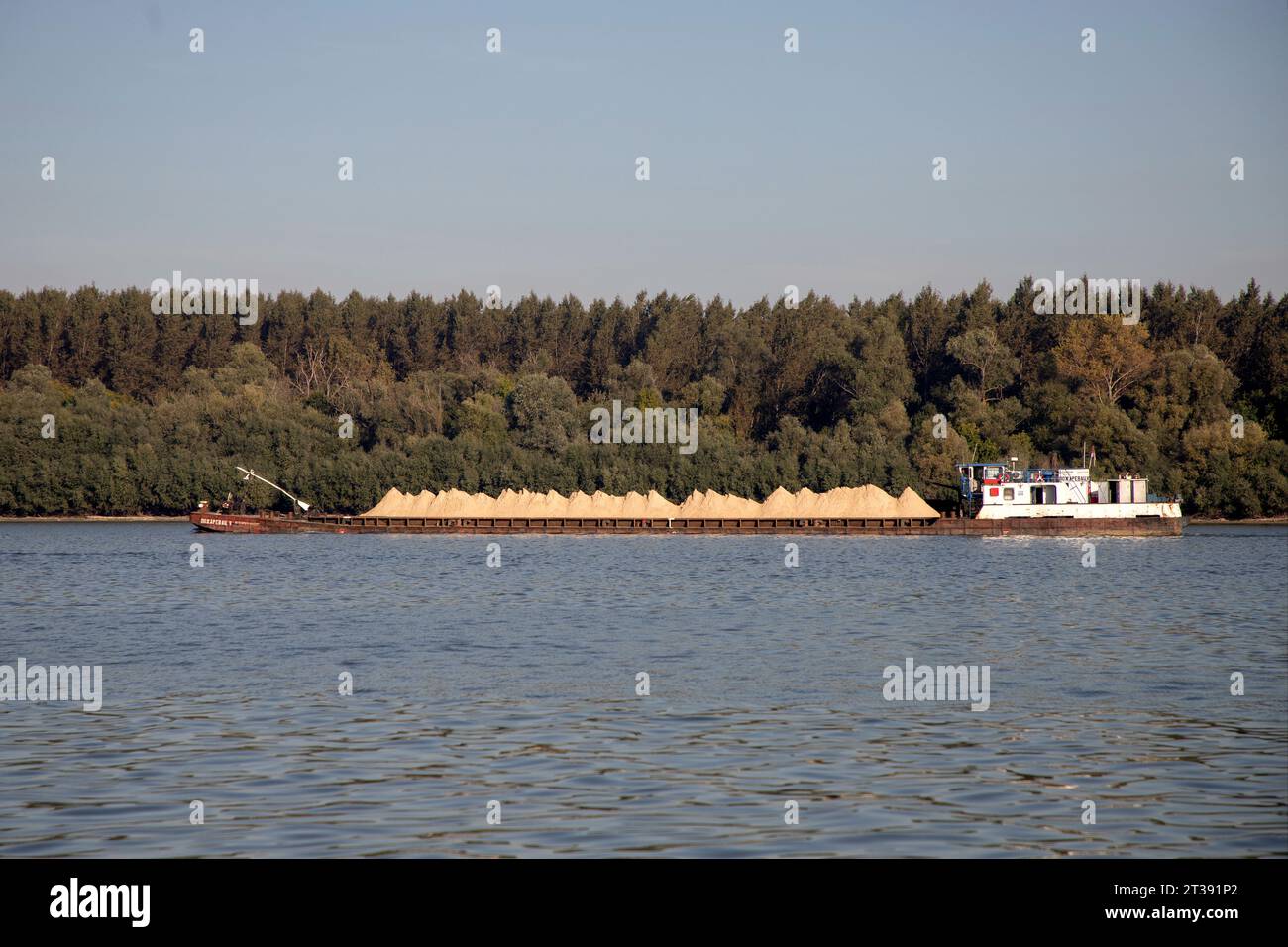 An inland river barge loaded with sand sailing down the Danube River ...