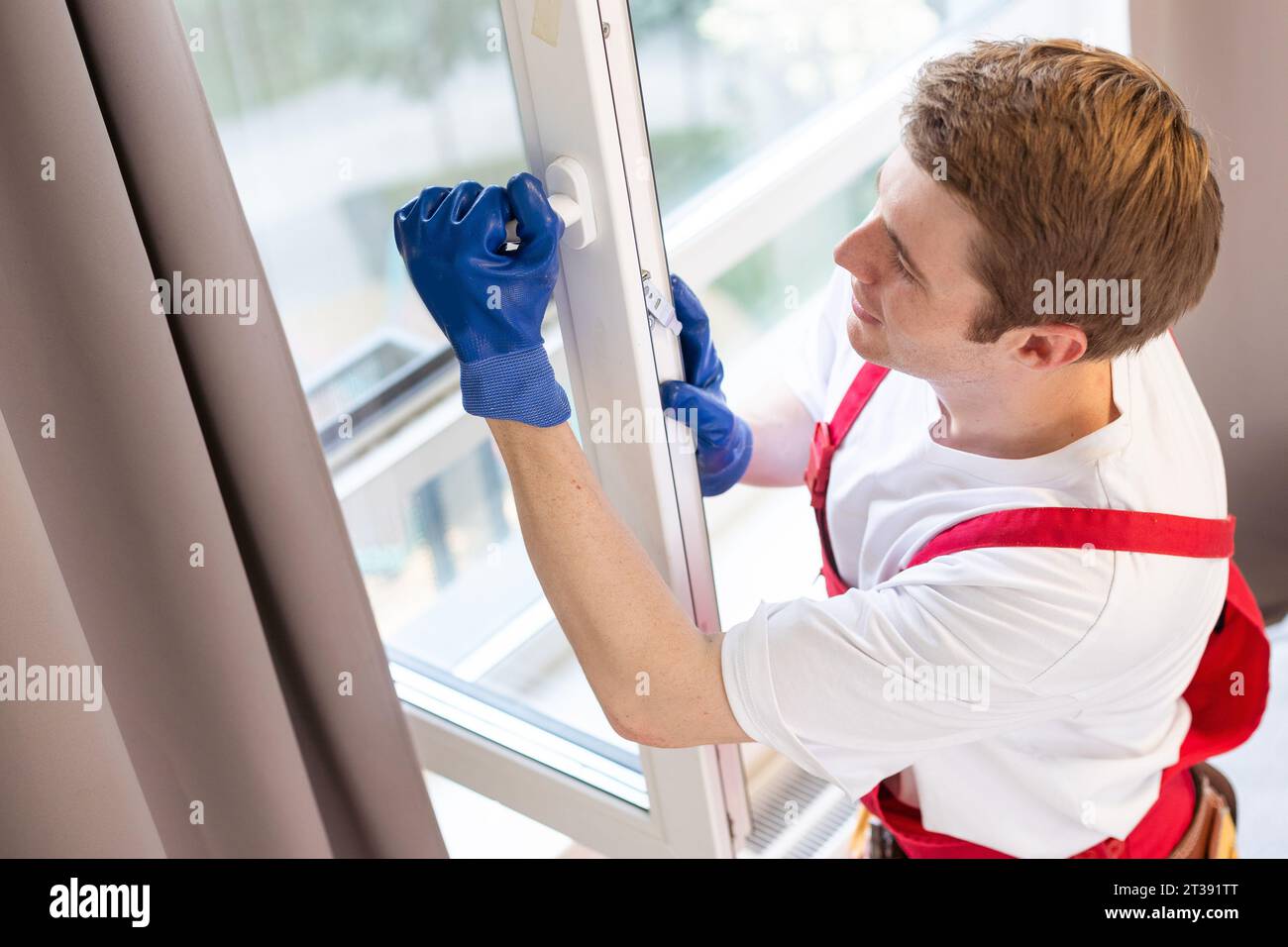 Construction worker installing window in house Stock Photo - Alamy