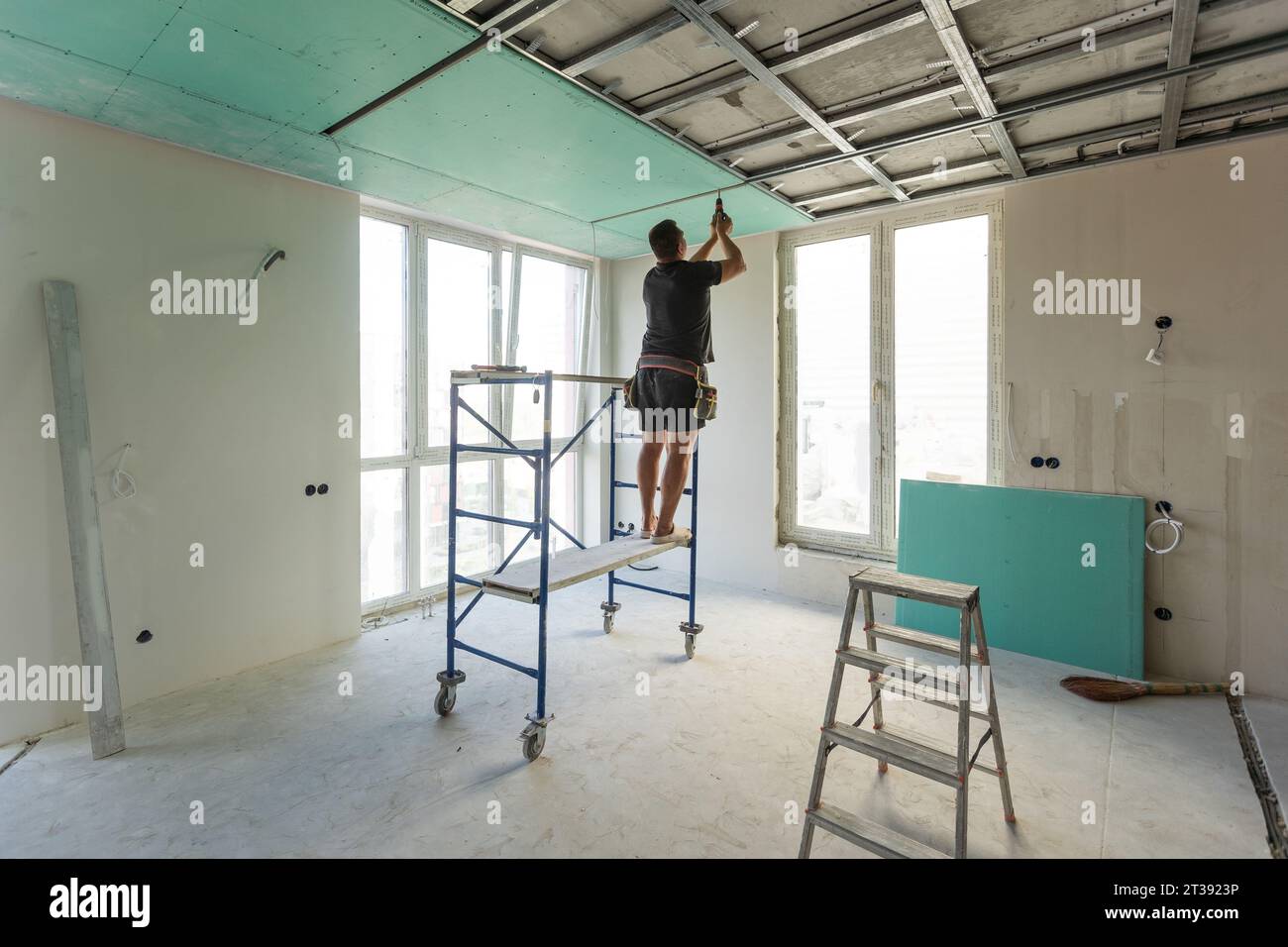 Man assembles profile metal frame for plasterboard ceilings Stock Photo ...