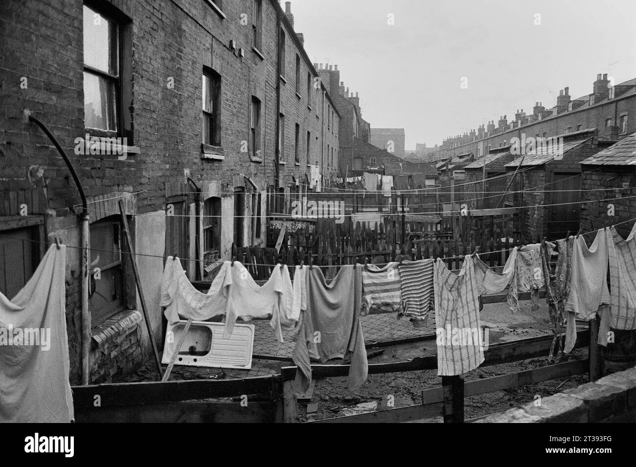 Lines of washing hanging in the back yards of a street of Victorian ...