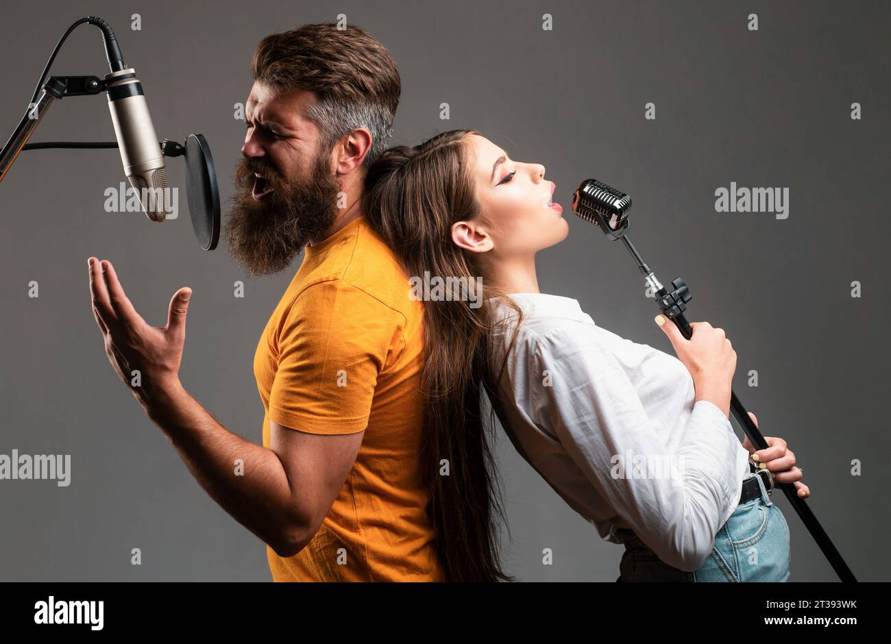 Couple singing. Singing man and girl in a recording studio. Expressive ...