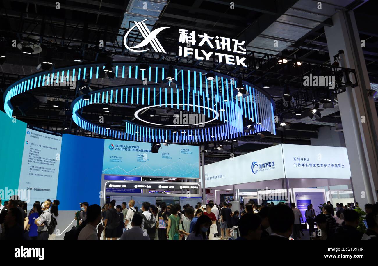 Shanghai, China. 24th Oct, 2023. Spectators look at IFlytek's Spark ...