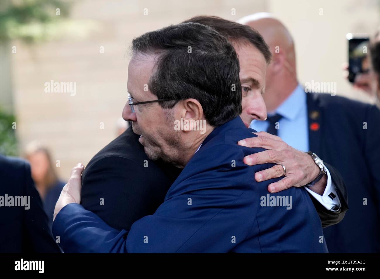 French President Emmanuel Macron, right, hugs Israel's President Isaac ...