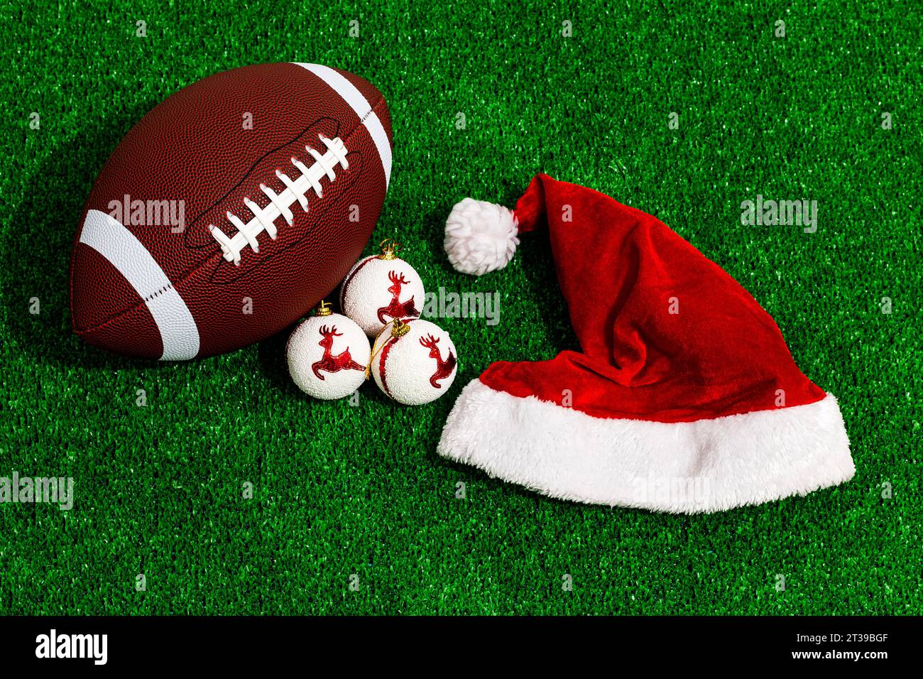 American football ball next to Christmas tree decorative balls and ...