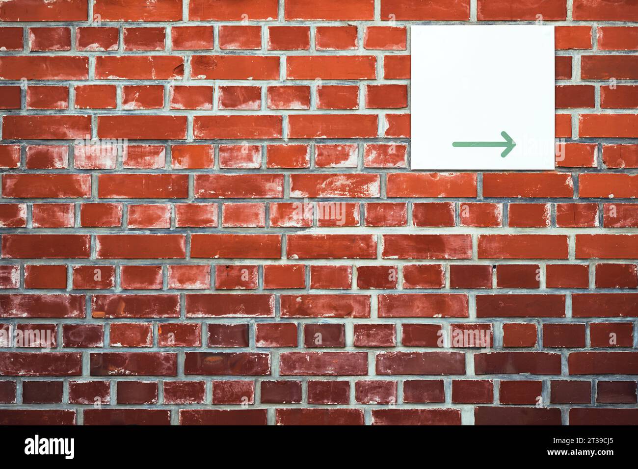 Direction arrow sign board on brick wall facade with copy space Stock ...