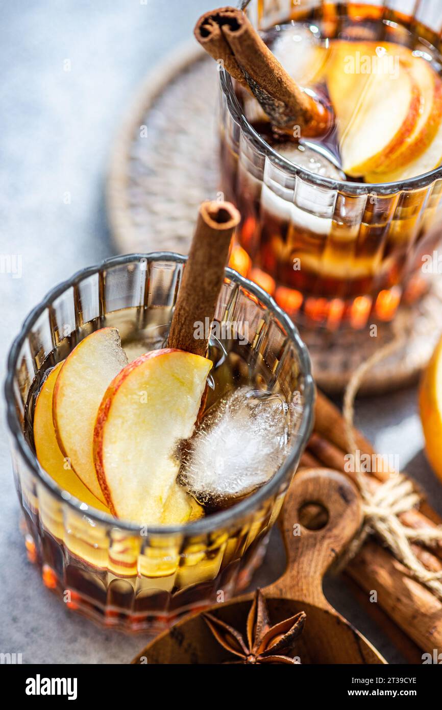 Fresh apple cider cocktails garnished with cinnamon sticks, star anise ...